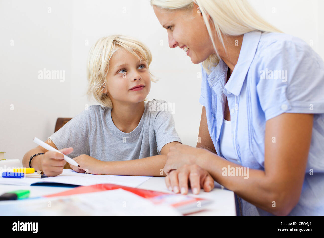Mother helping son with homework Stock Photo - Alamy