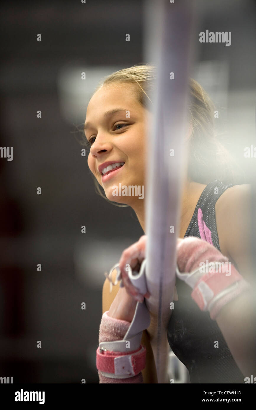 Female gymnast leaning against horizontal bar, portrait Stock Photo - Alamy