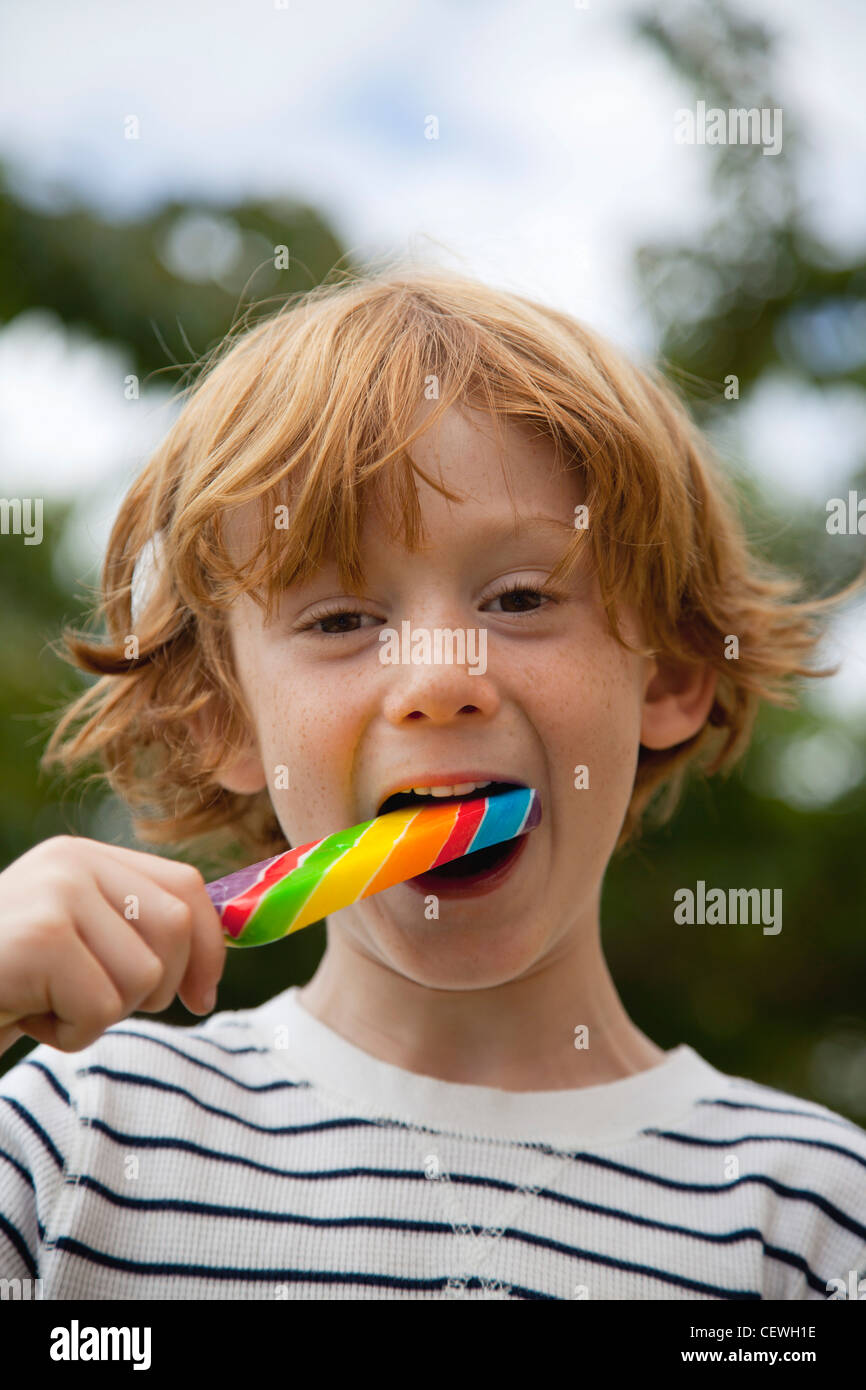 Boy eating lollipop Stock Photo - Alamy