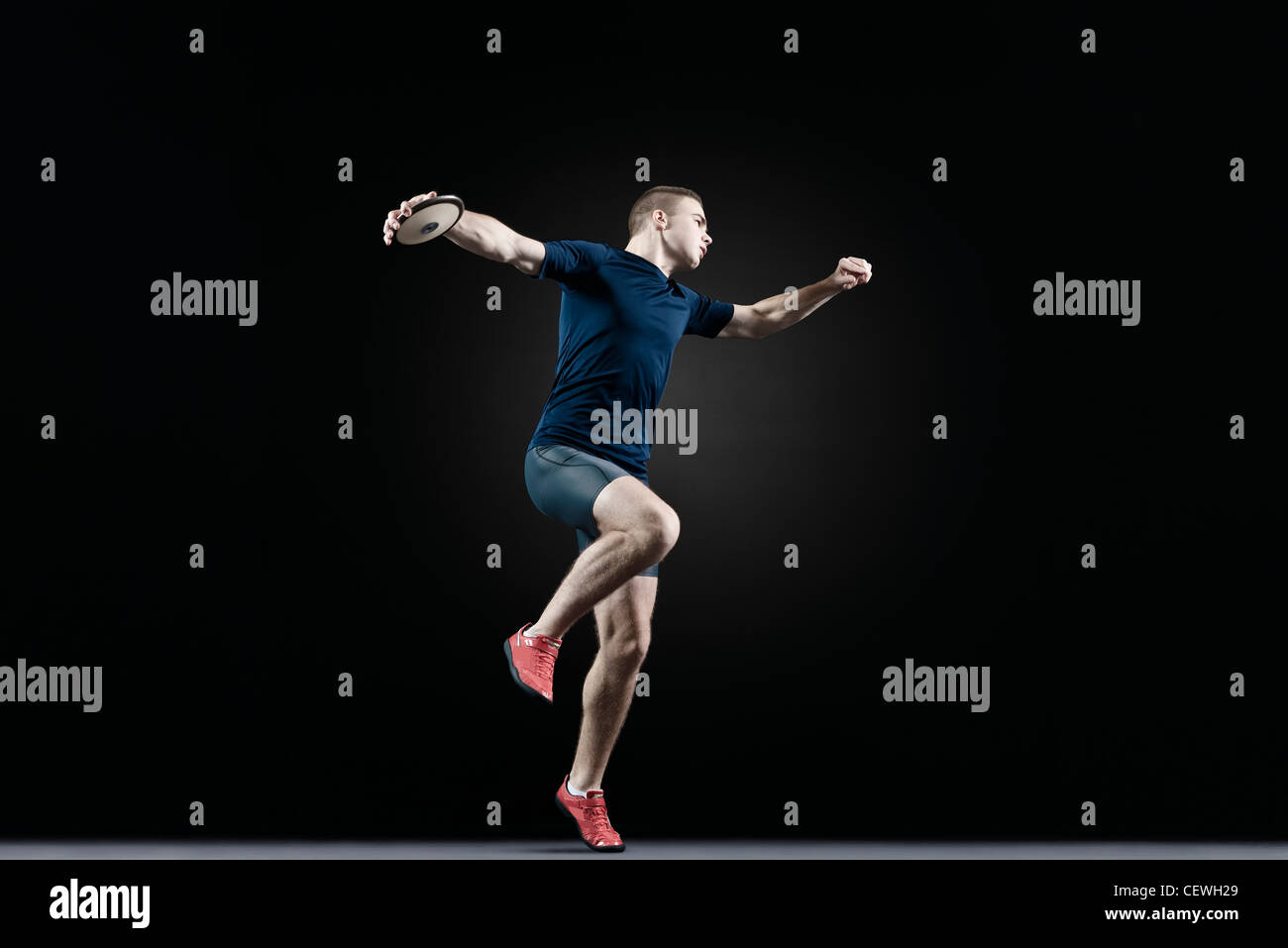 Male athlete throwing discus Stock Photo - Alamy