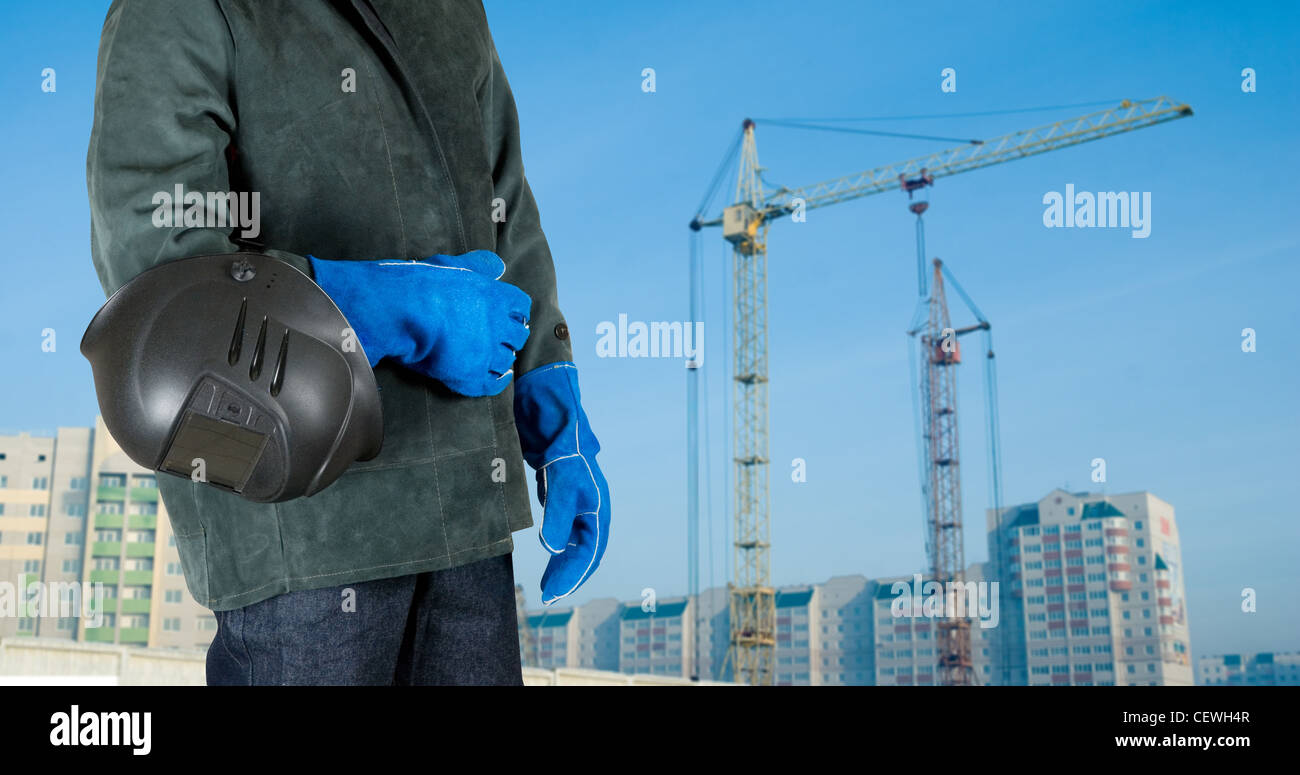 male welder closeup with welding equipment on building background Stock ...