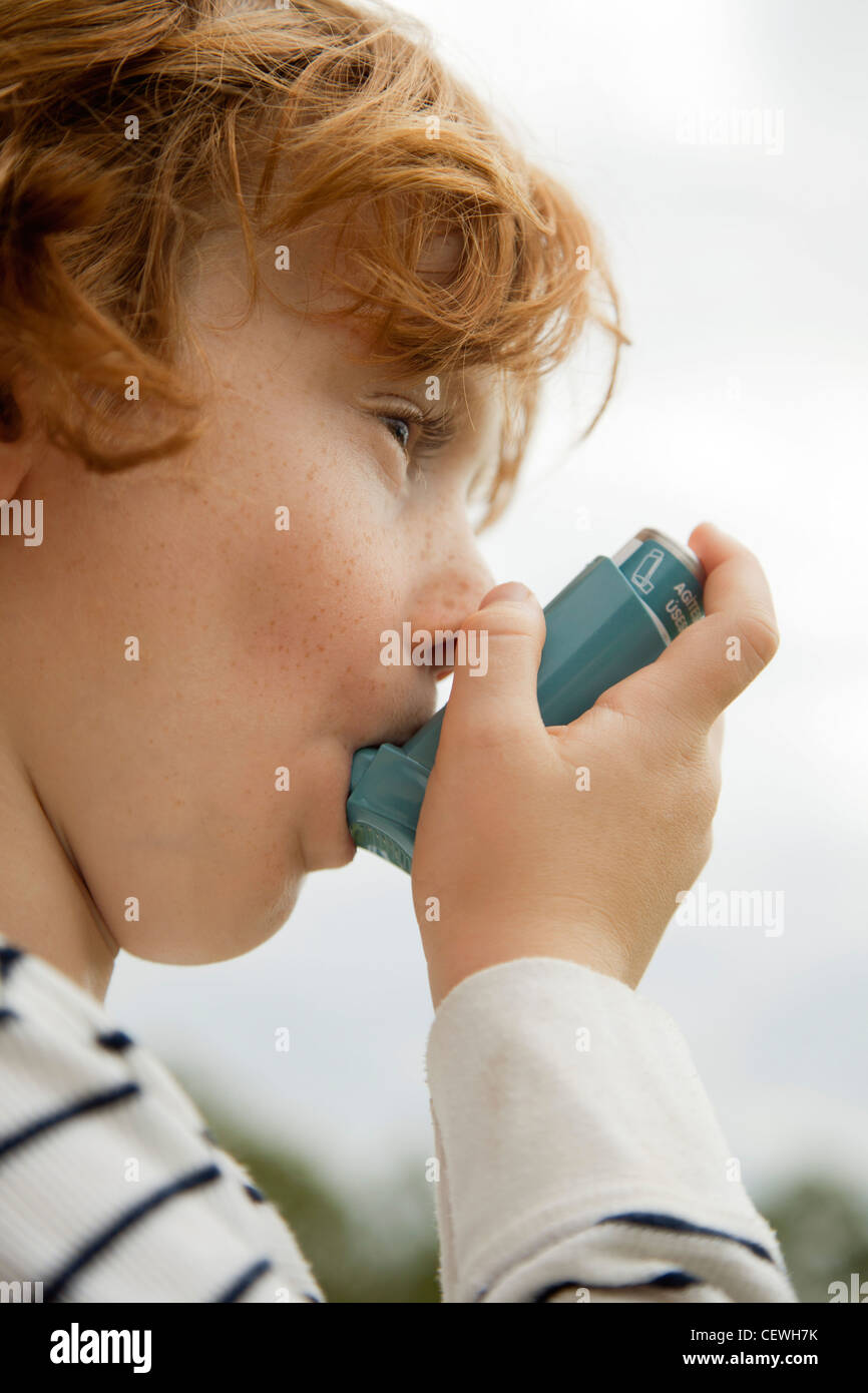 Boy using asthma inhaler Stock Photo - Alamy