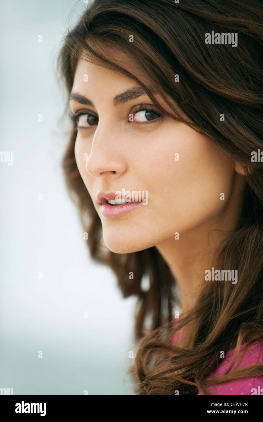 Woman glancing sideways at camera, portrait Stock Photo - Alamy