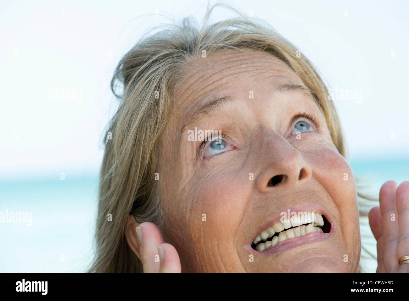 Senior woman making surprised face, portrait Stock Photo - Alamy