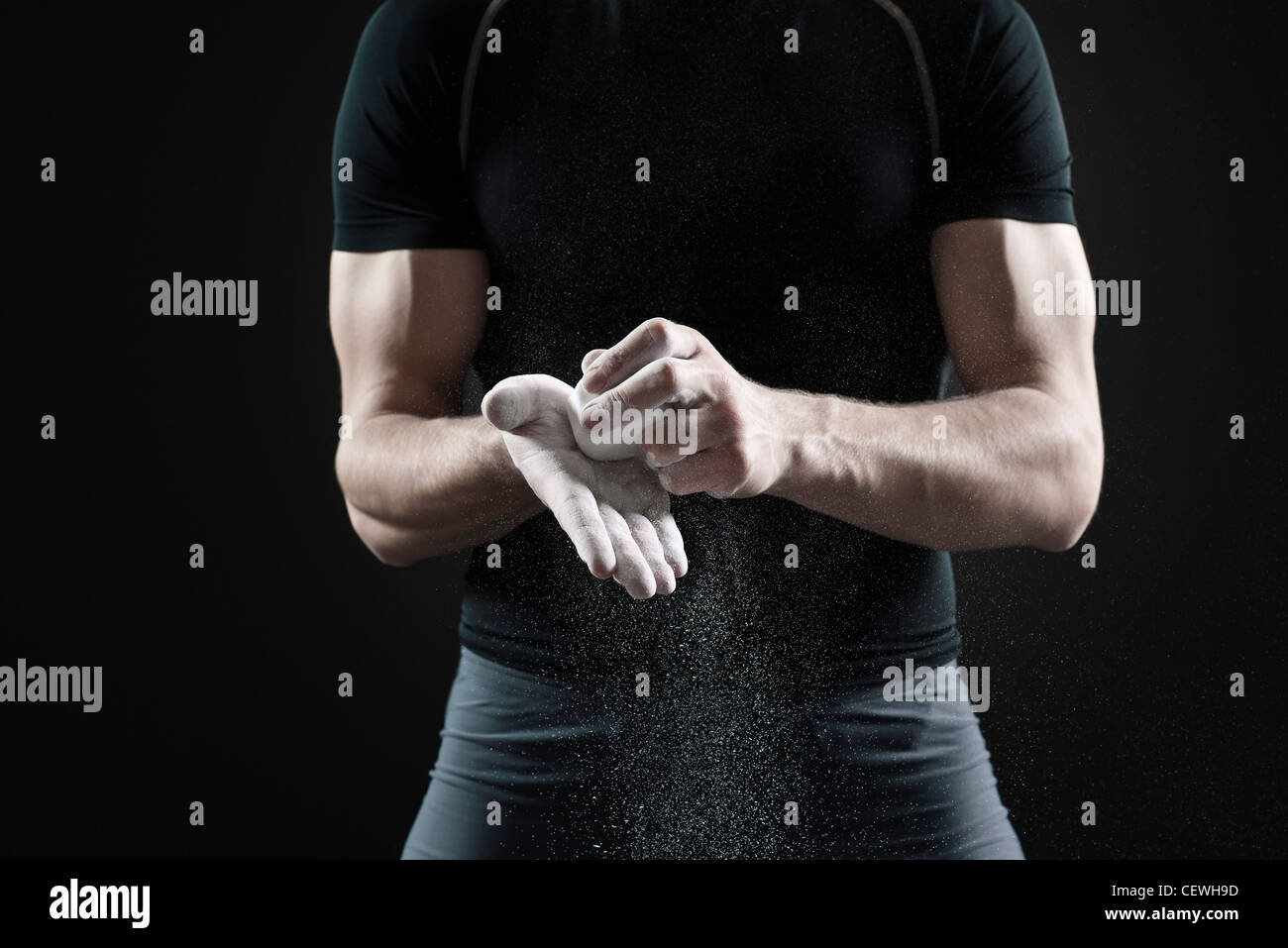 Male athlete applying chalk to hands, mid section Stock Photo - Alamy