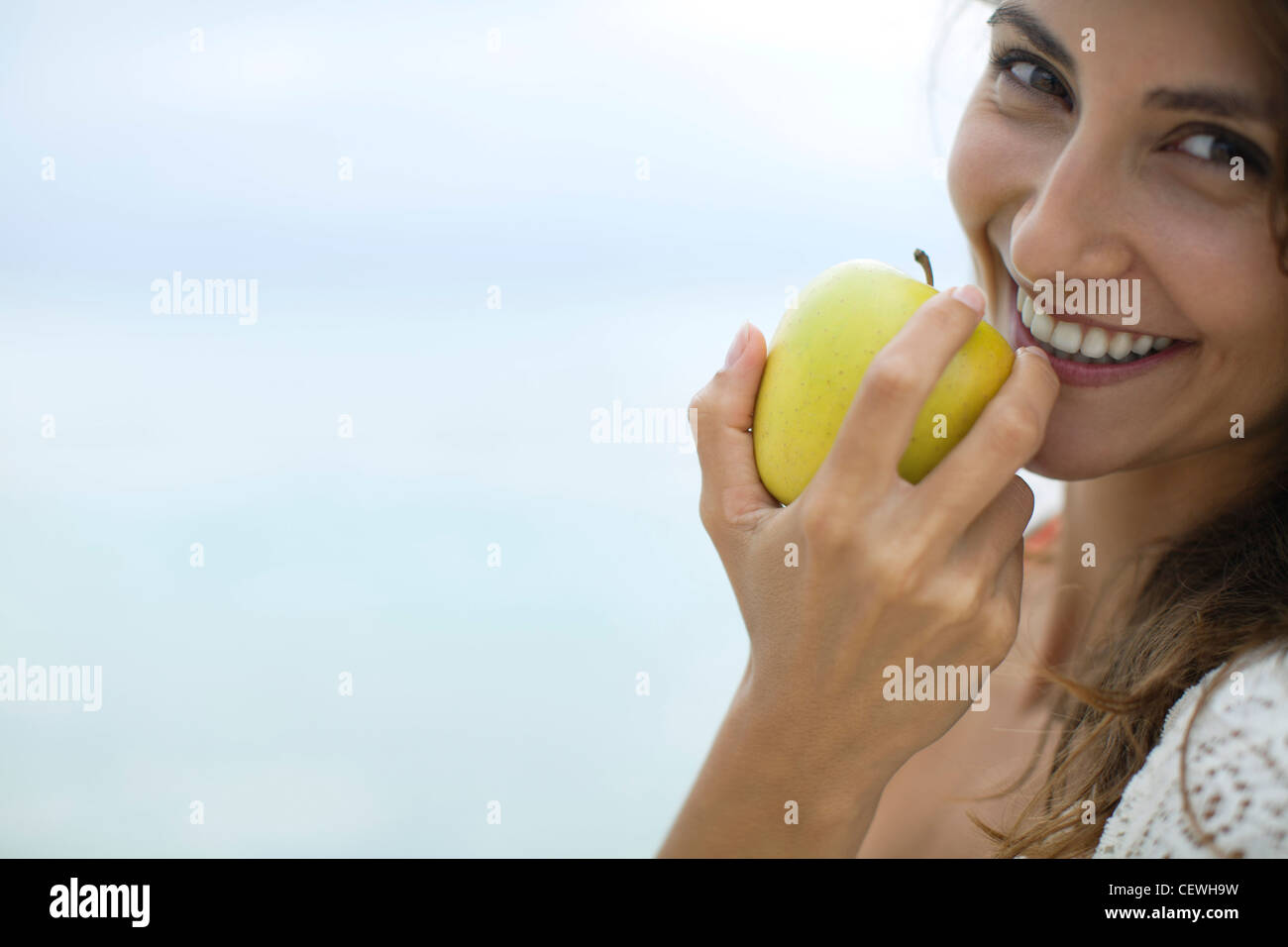 Woman eating apple, portrait Stock Photo - Alamy