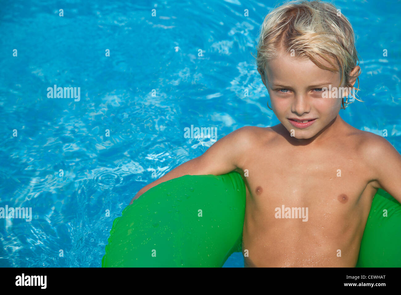 Boy relaxing on float in pool Stock Photo - Alamy