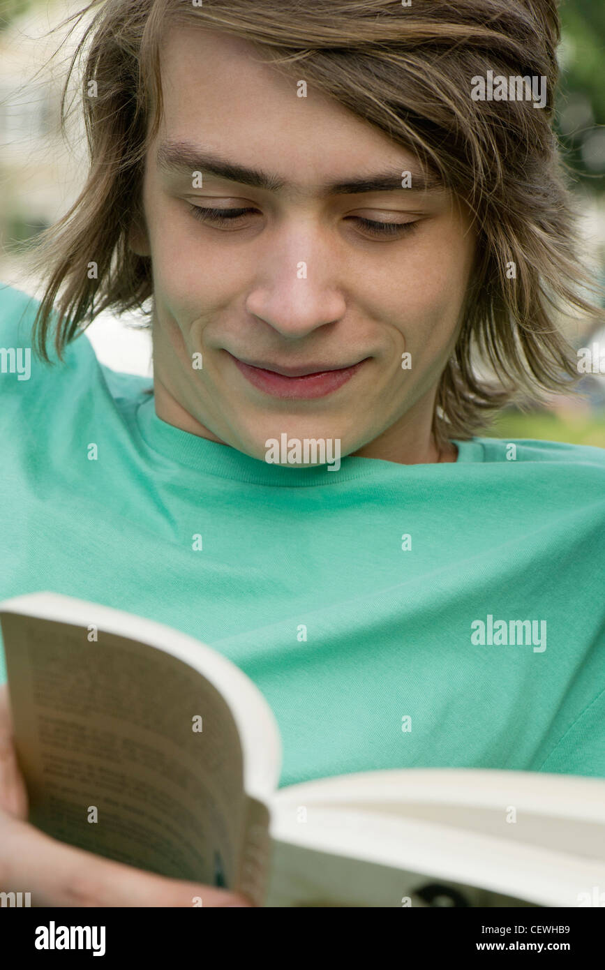 Young man reading book Stock Photo - Alamy