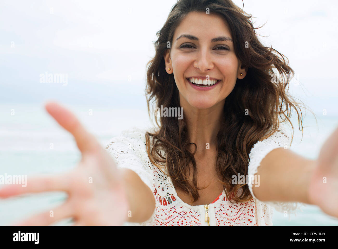 Woman reaching arms toward camera, smiling Stock Photo - Alamy