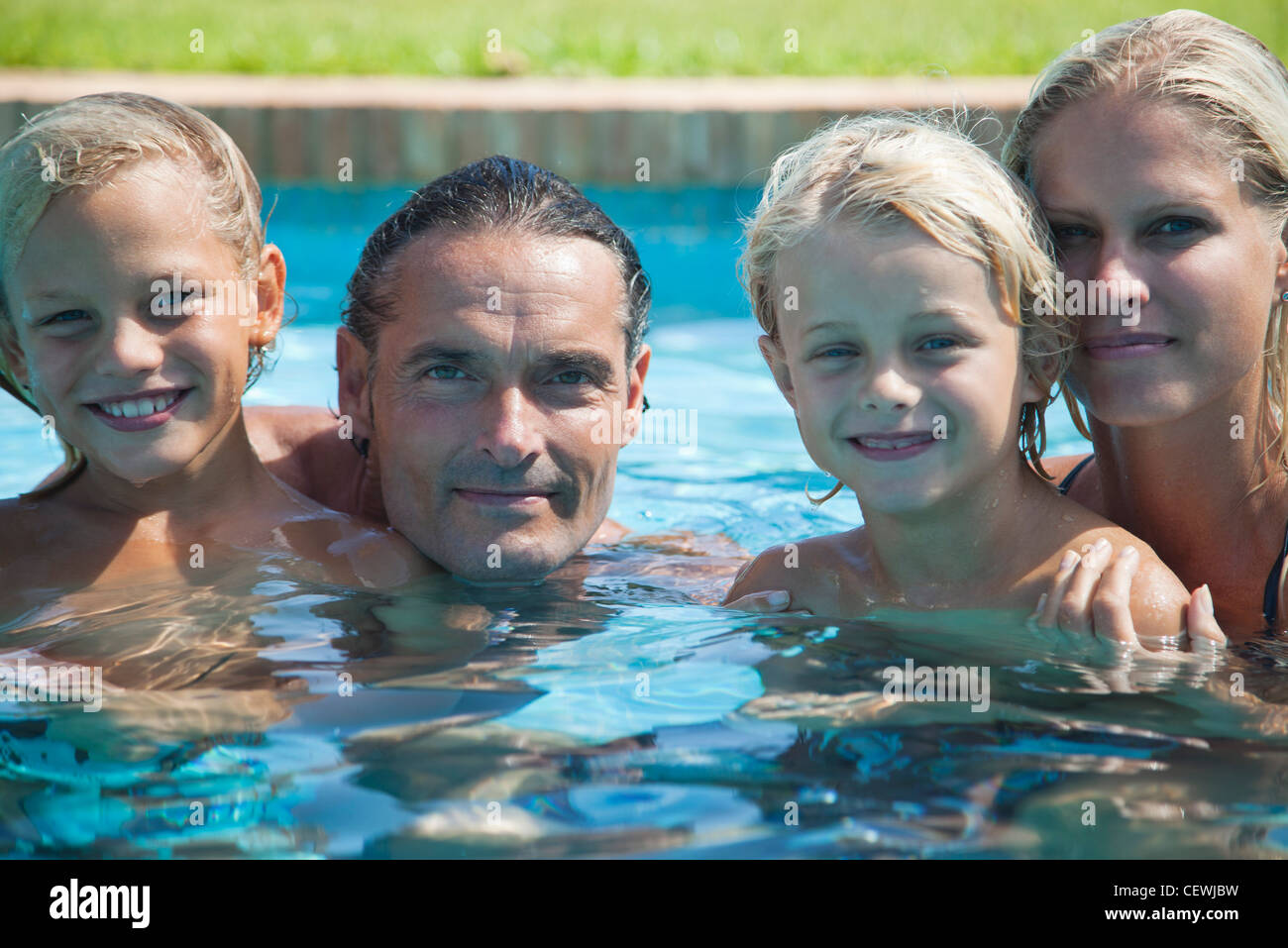 Family in swimming pool, portrait Stock Photo - Alamy