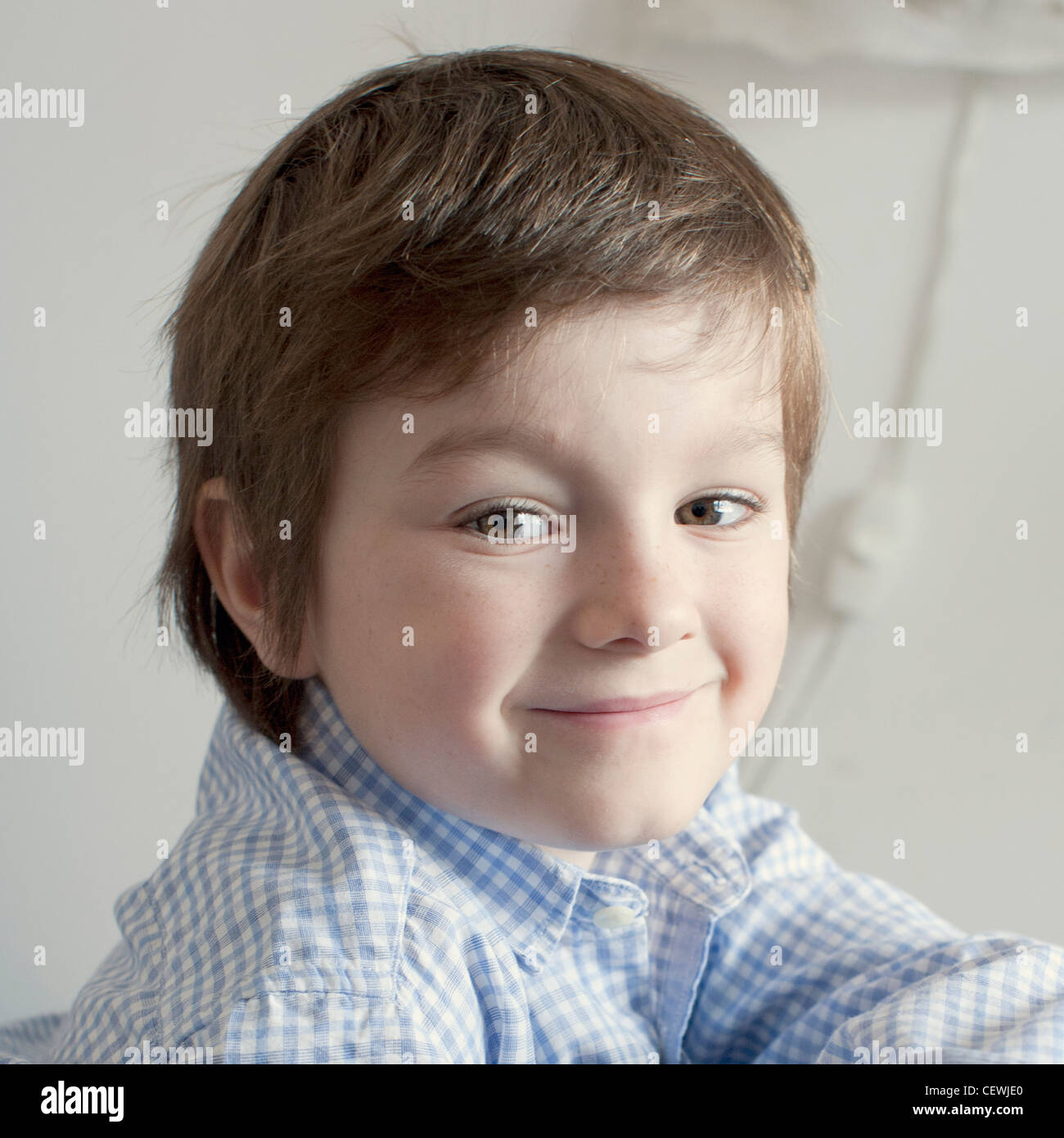 Boy smiling over shoulder, portrait Stock Photo - Alamy