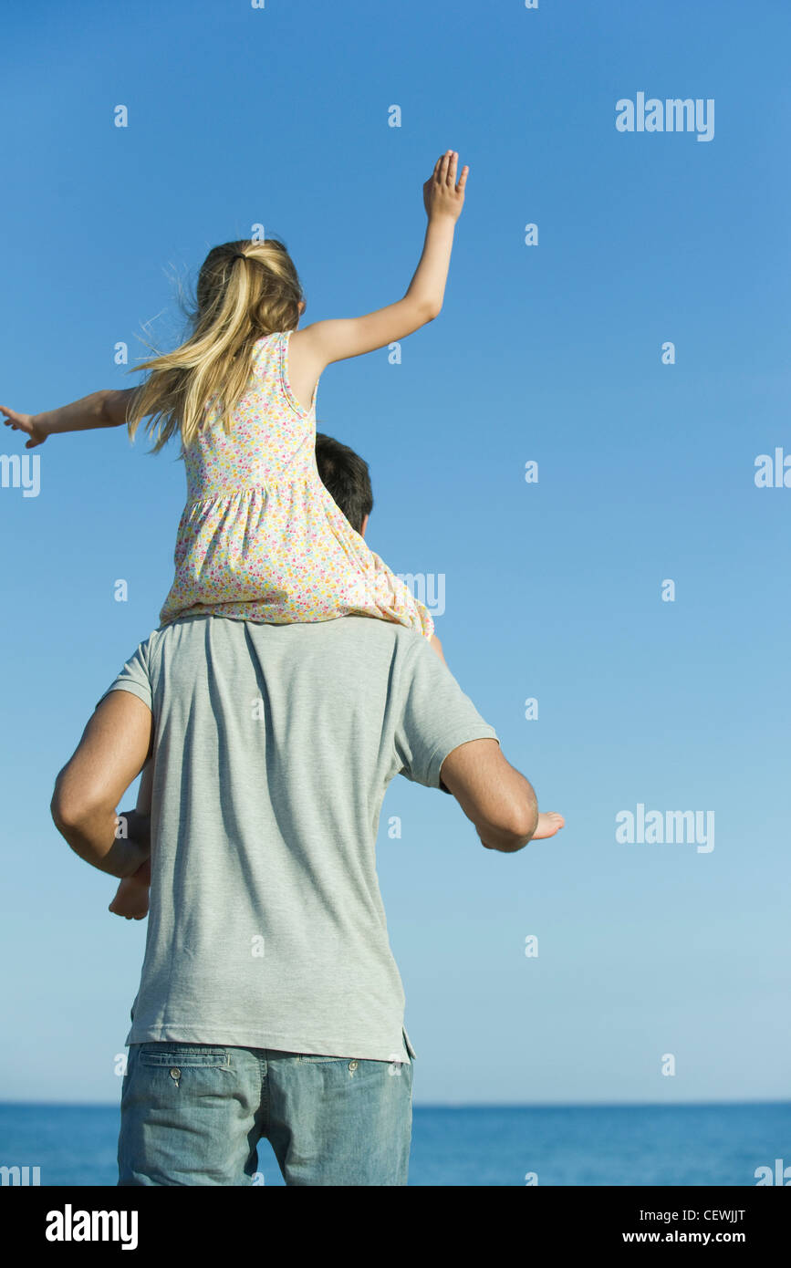 Father carrying daughter on his shoulders, rear view Stock Photo - Alamy