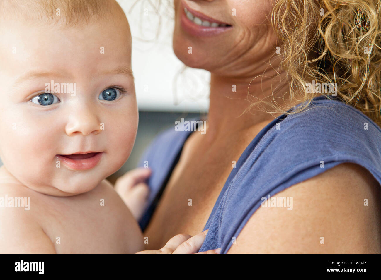 Baby in mother's arms, cropped Stock Photo - Alamy