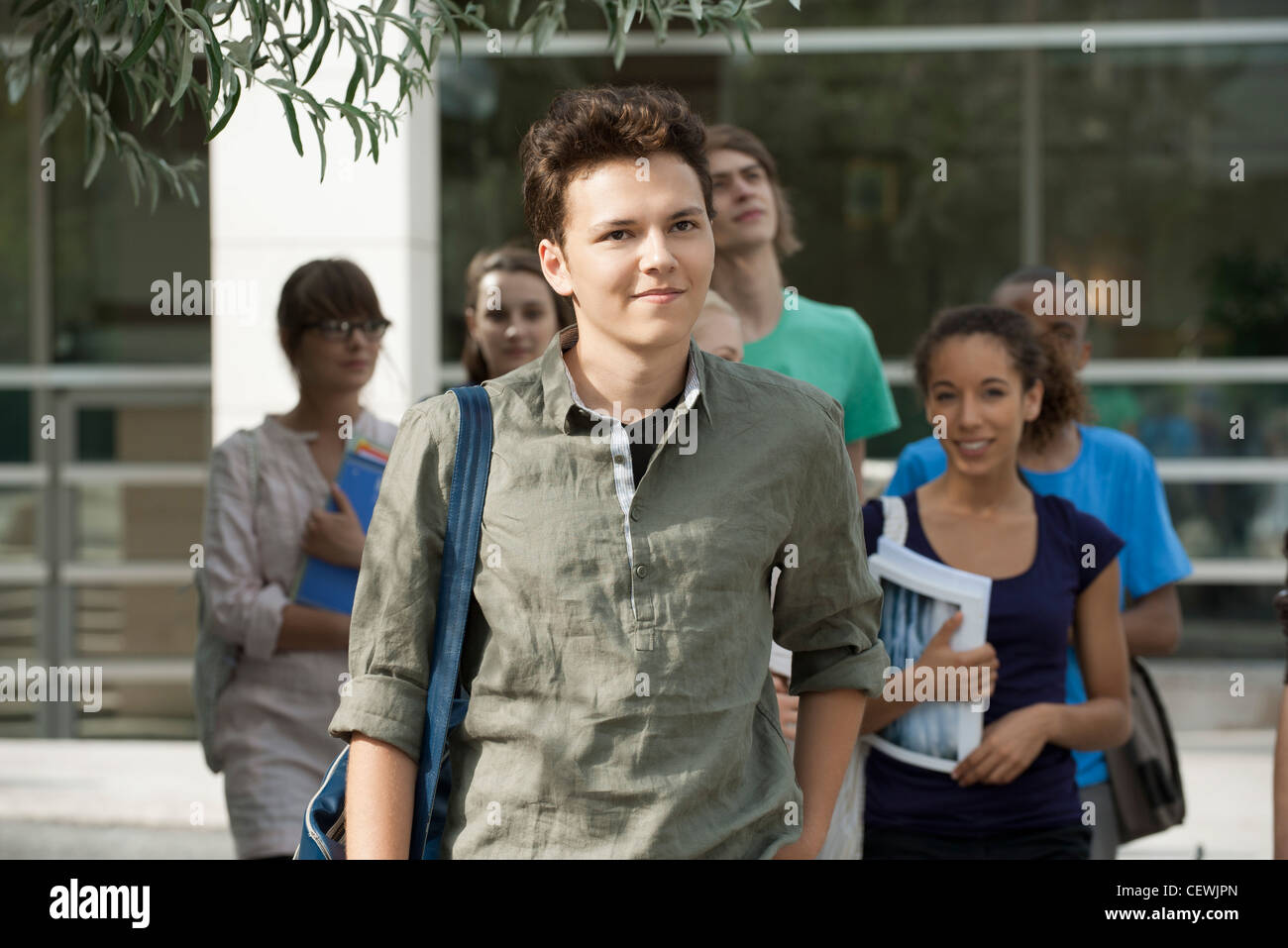 Male university student, friends in background Stock Photo - Alamy