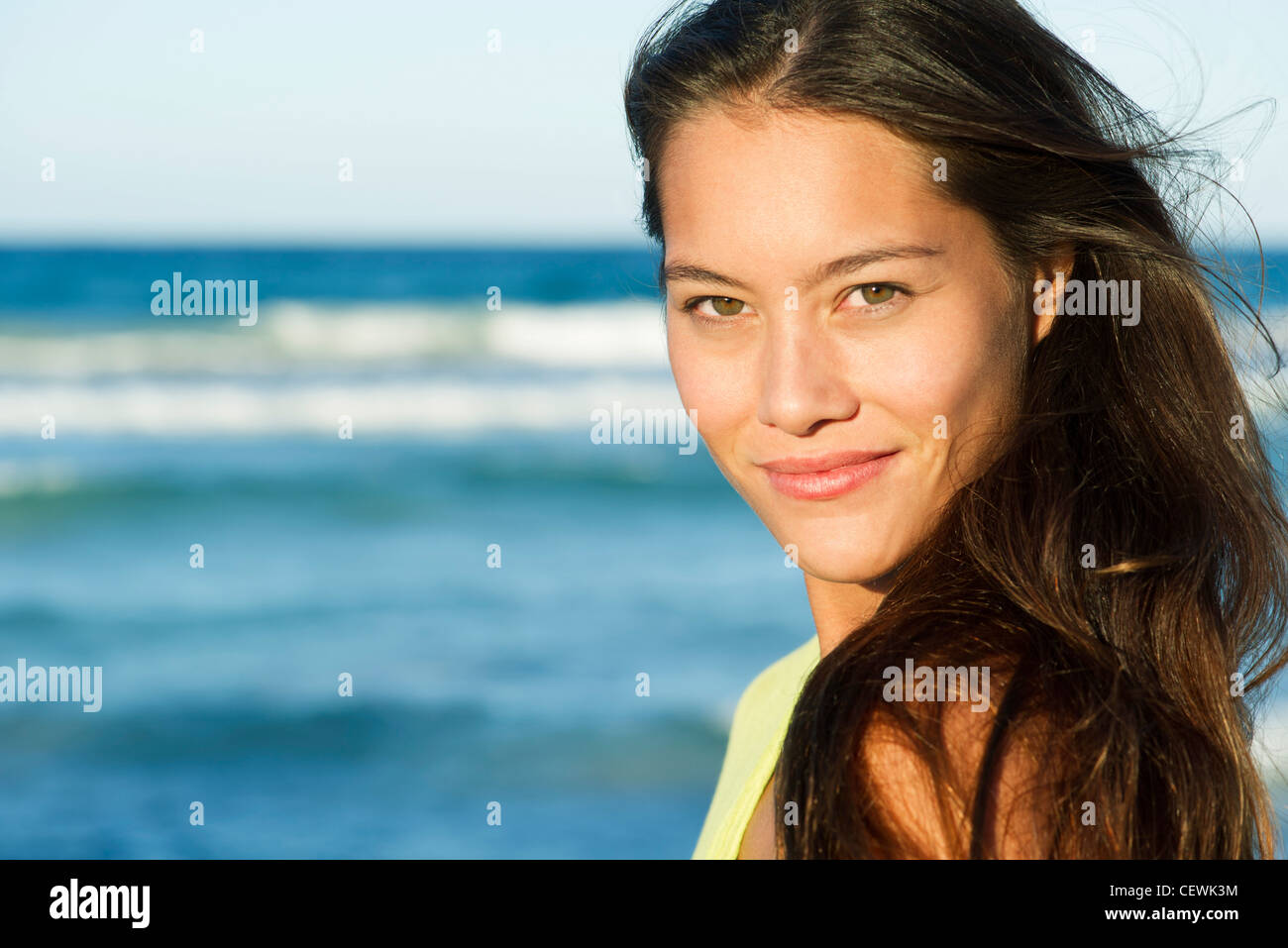 Young woman by sea, portrait Stock Photo - Alamy