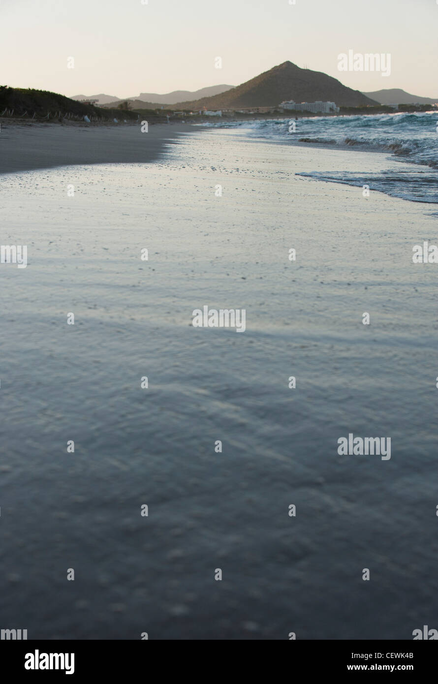 Waves lapping onto beach Stock Photo - Alamy