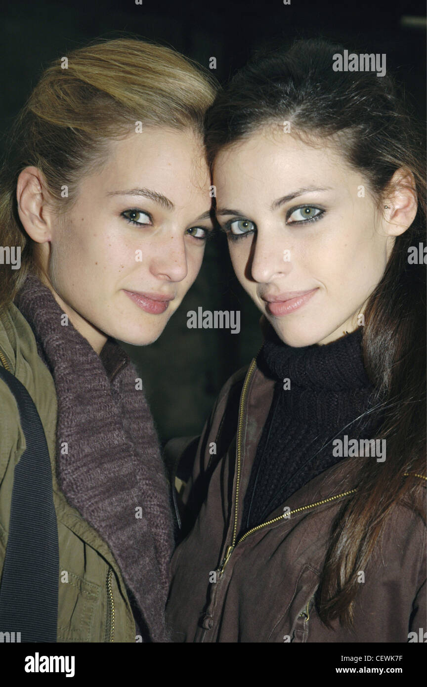 Two models one brunette and one blonde, standing with their heads ...