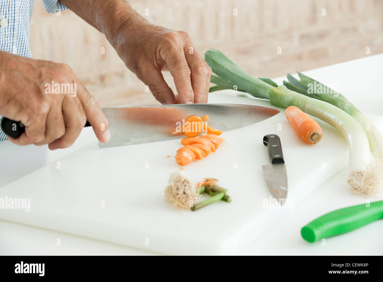 Man slicing fresh vegetables, cropped Stock Photo - Alamy