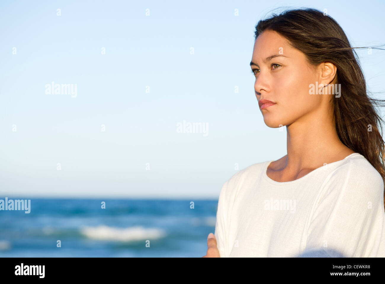 Young woman contemplating over ocean view, portrait Stock Photo - Alamy