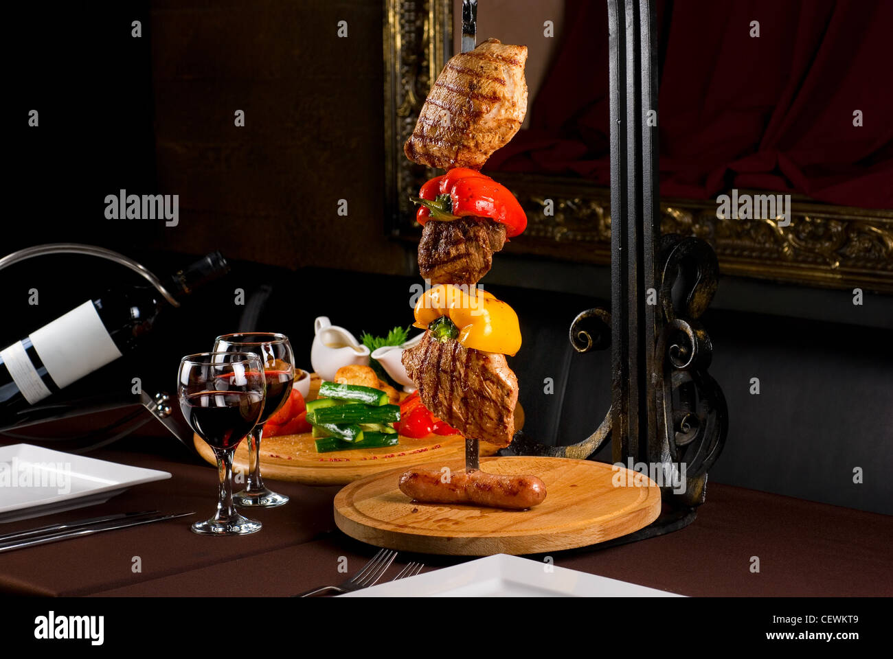 Big tasty roasted meat cuts at skewer on a decorated table Stock Photo ...