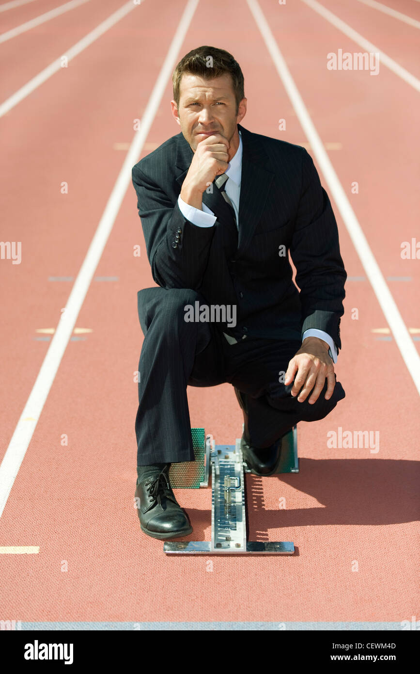 Man in suit crouching on hi-res stock photography and images - Alamy