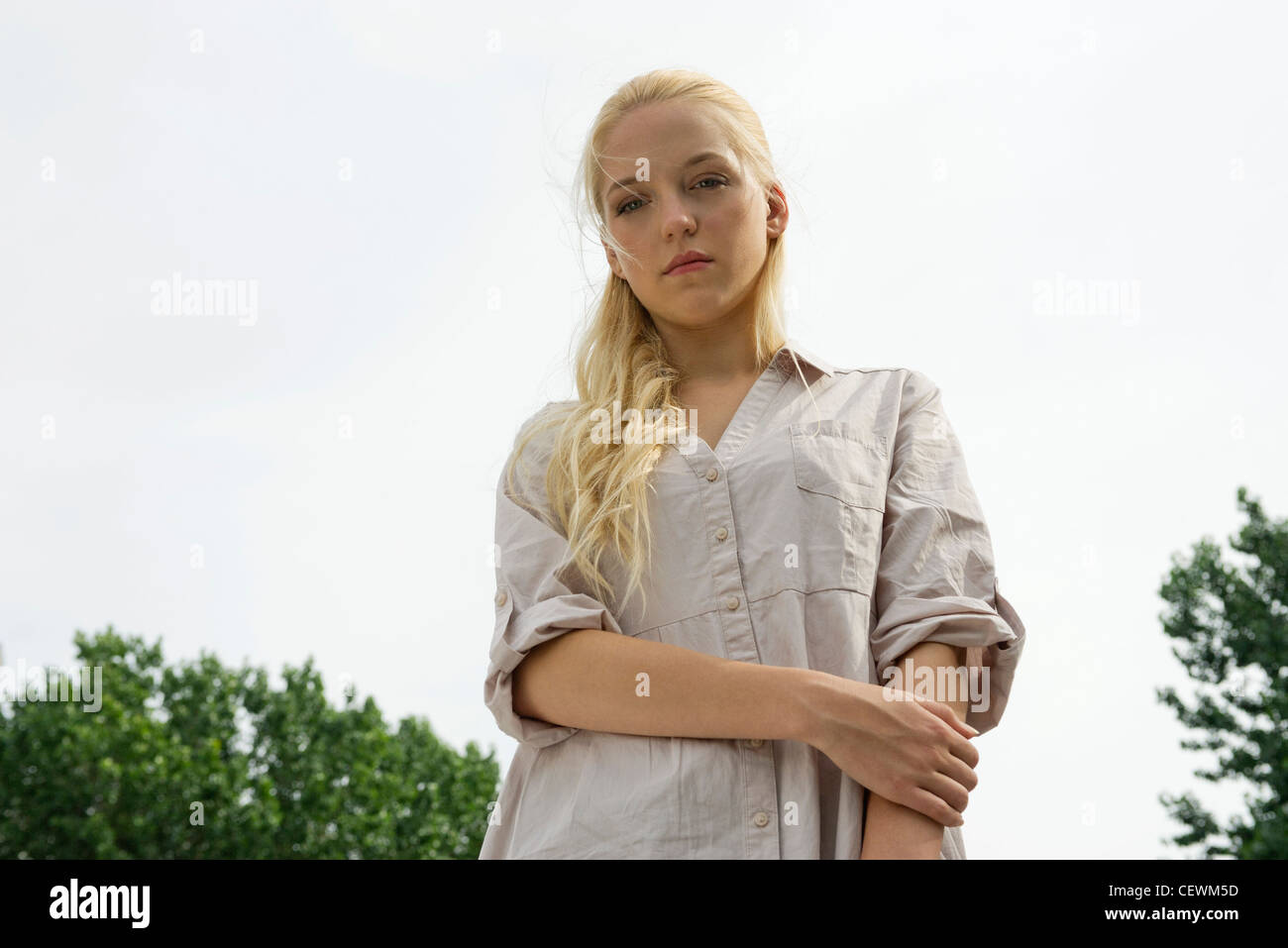 Young woman looking at camera with sad expression Stock Photo - Alamy
