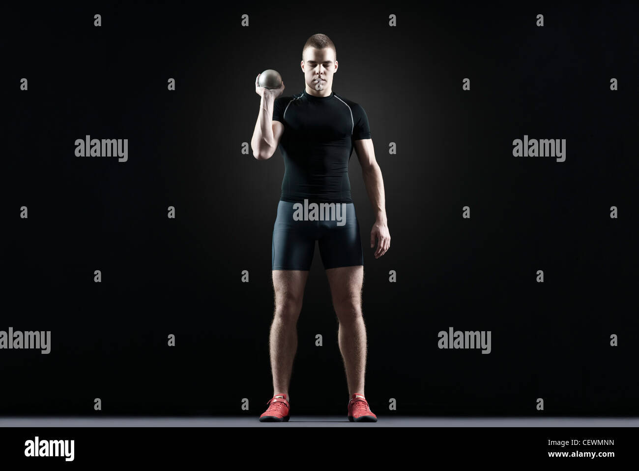 Shot putter holding shot Stock Photo - Alamy
