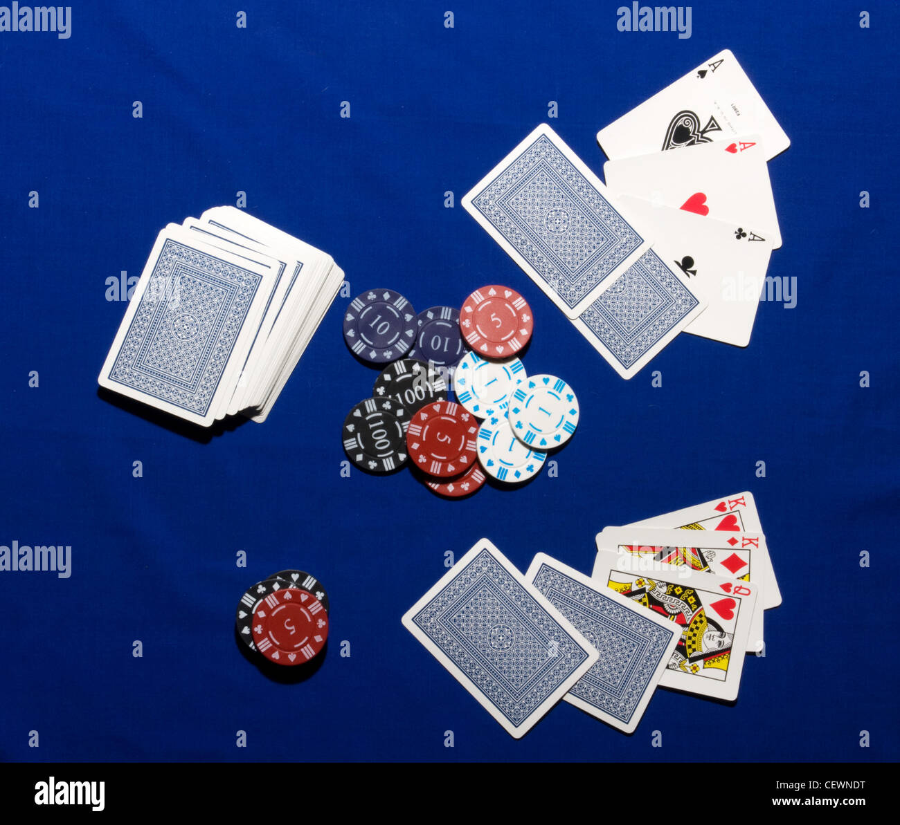 Two player poker hands layed out on blue background with two hidden ...