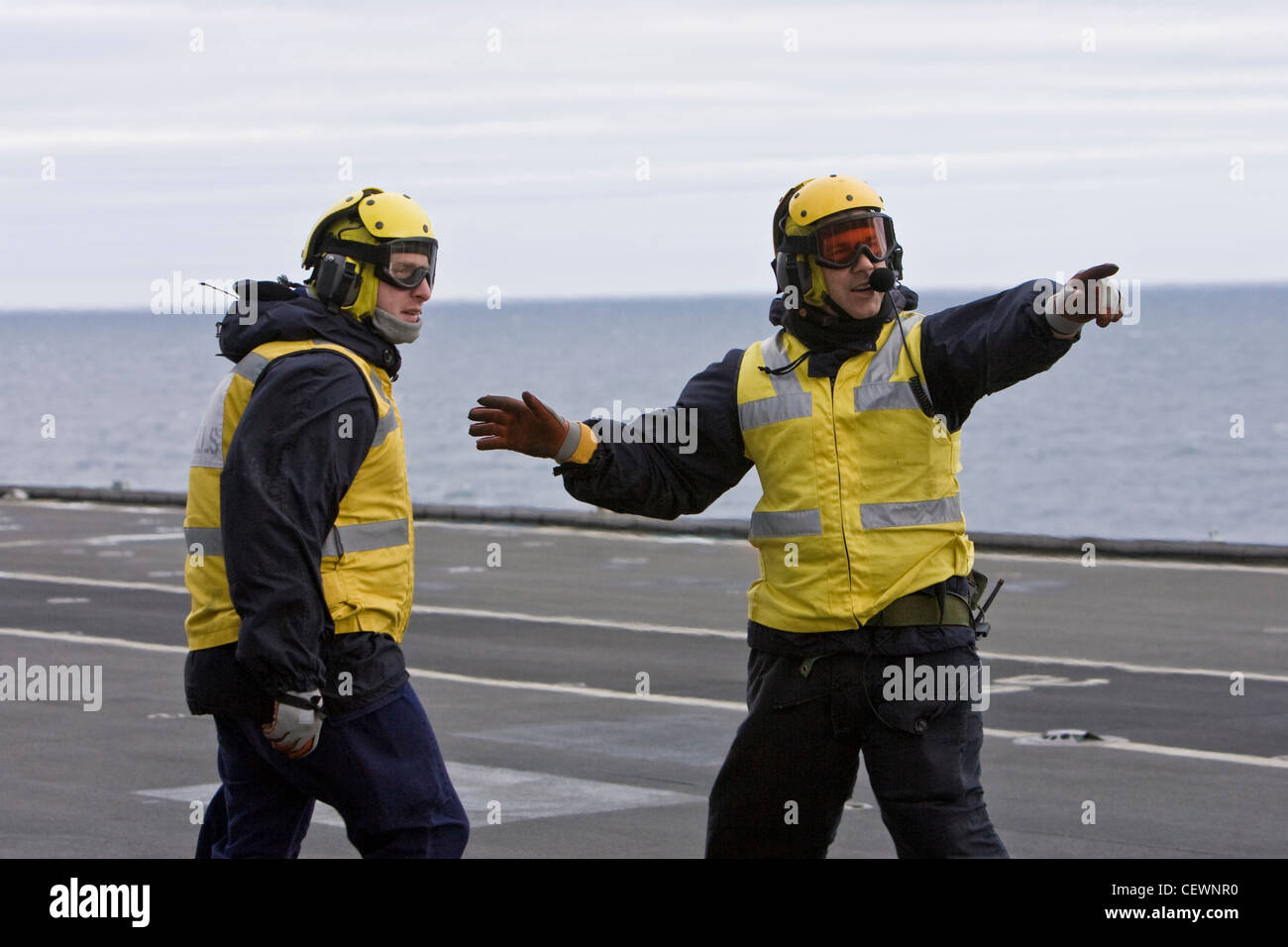 Crewmen on naval aircraft carrier ship, HMS Illustrius Stock Photo - Alamy