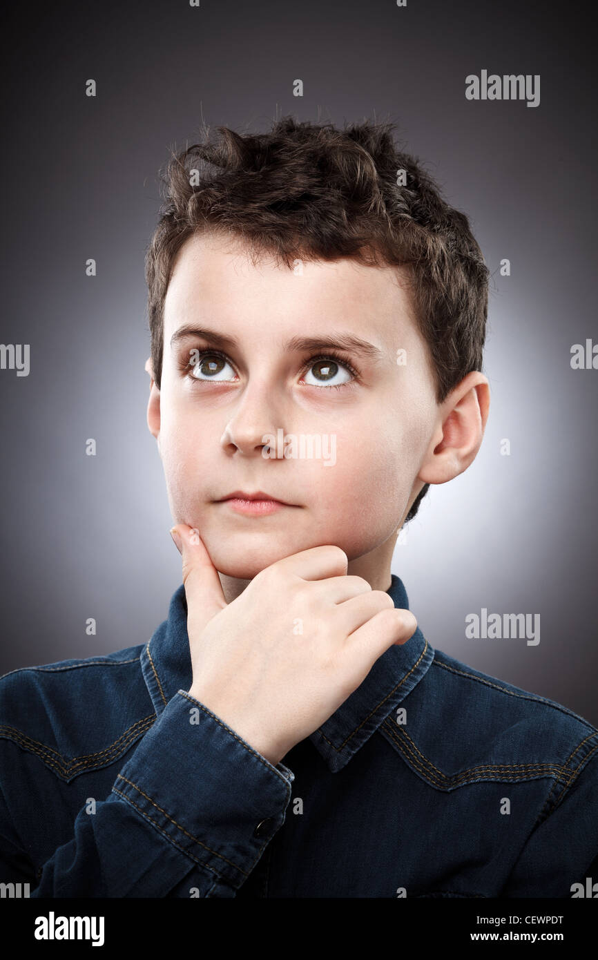Studio closeup portrait of a boy thinking Stock Photo - Alamy