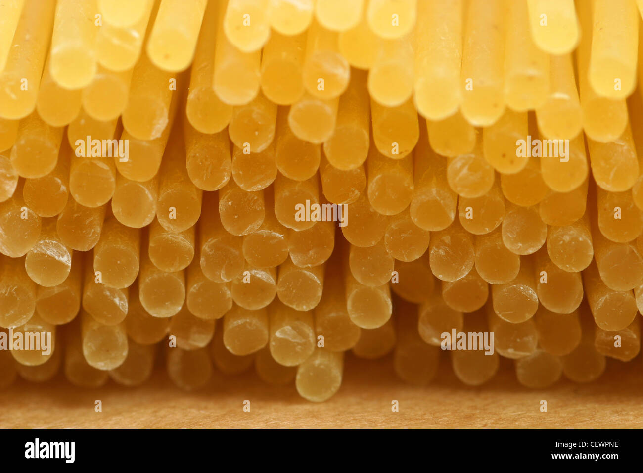 A close up of the ends of spaghetti lying on greaseproof paper Stock ...