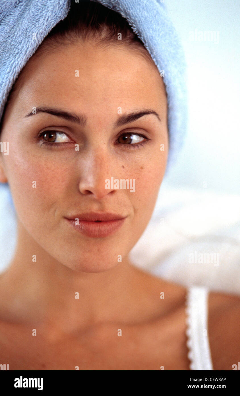 Female with brunette hair wearing white bra, pale blue towel wrapped ...