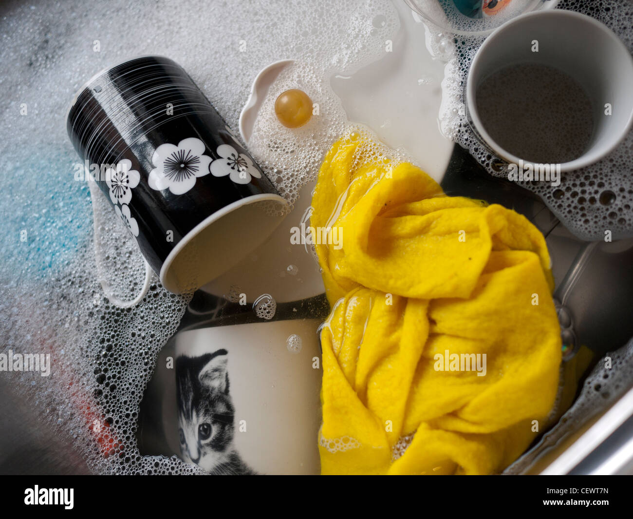 Cups and plates in washing sink Stock Photo - Alamy