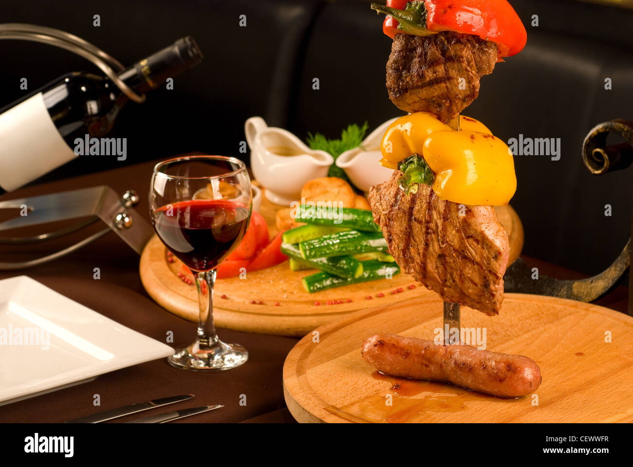 Big tasty roasted meat cuts at skewer on a decorated table Stock Photo ...