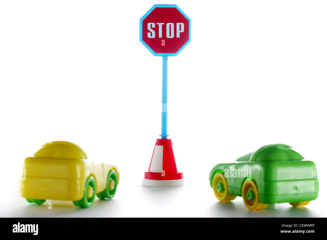 A couple cars behind stop road sign at white background Stock Photo - Alamy