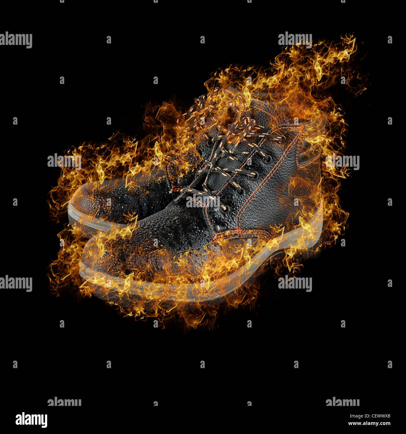 moist modern working boots at fire isolated on a black background Stock ...