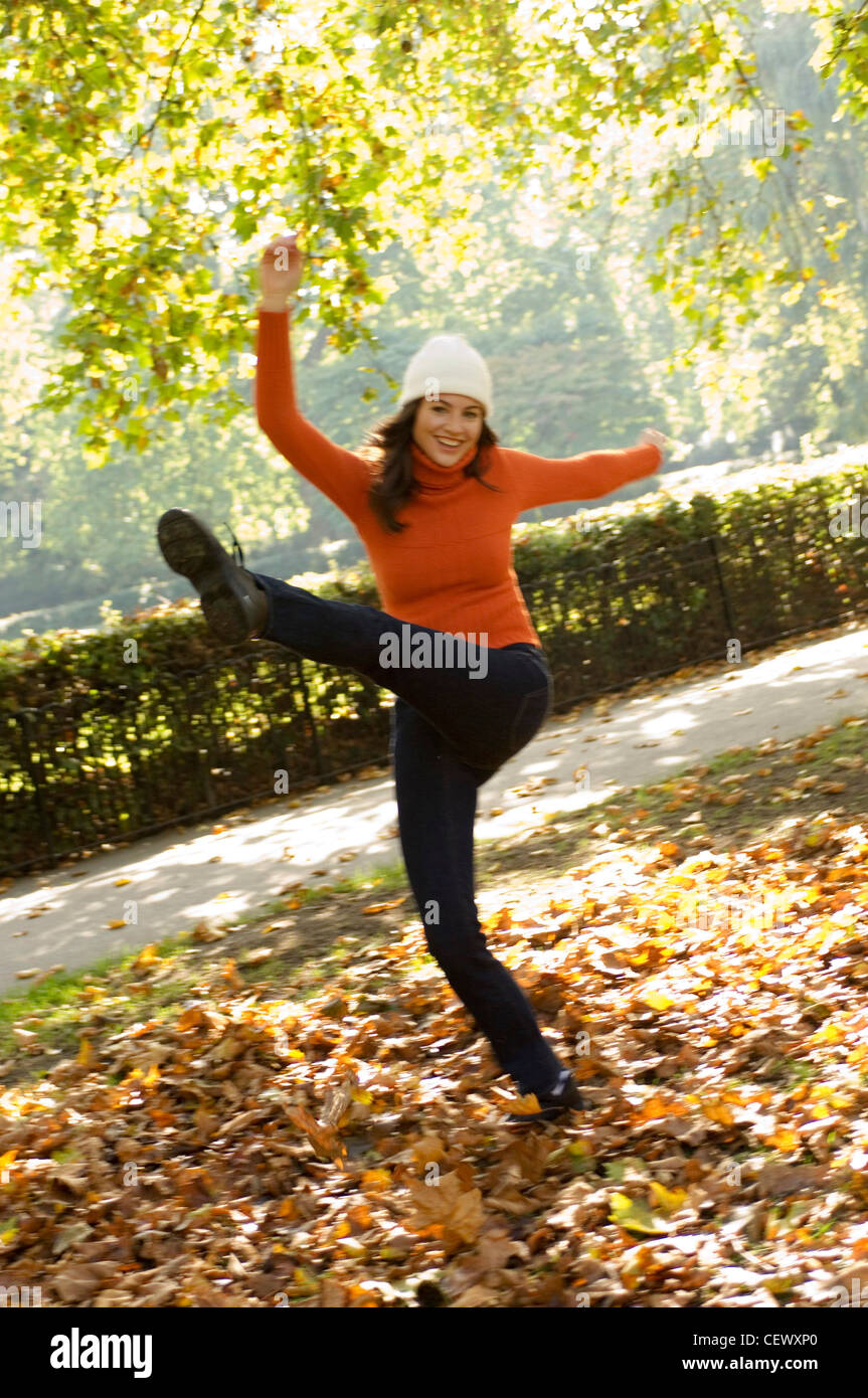 Female wearing dark blue jeans, orange polo neck jumper, cream hat ...