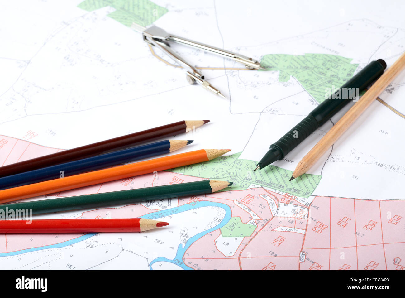 Topographic map of district with a measuring instrument and pencils ...