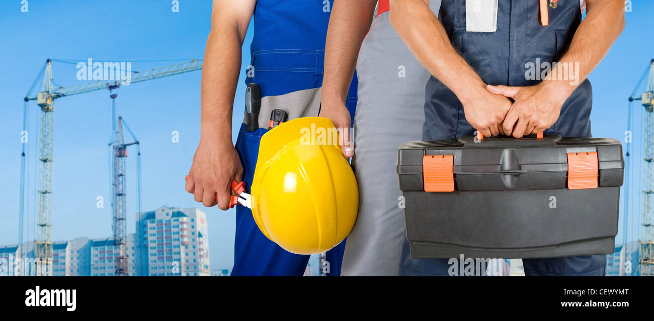 Different workers man closeup on building background Stock Photo - Alamy