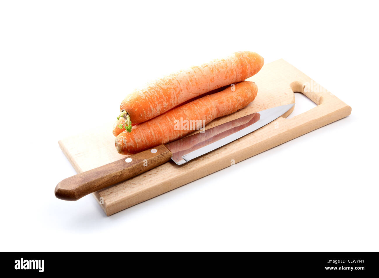 Carrots and knife on a chopping board white background Stock Photo - Alamy