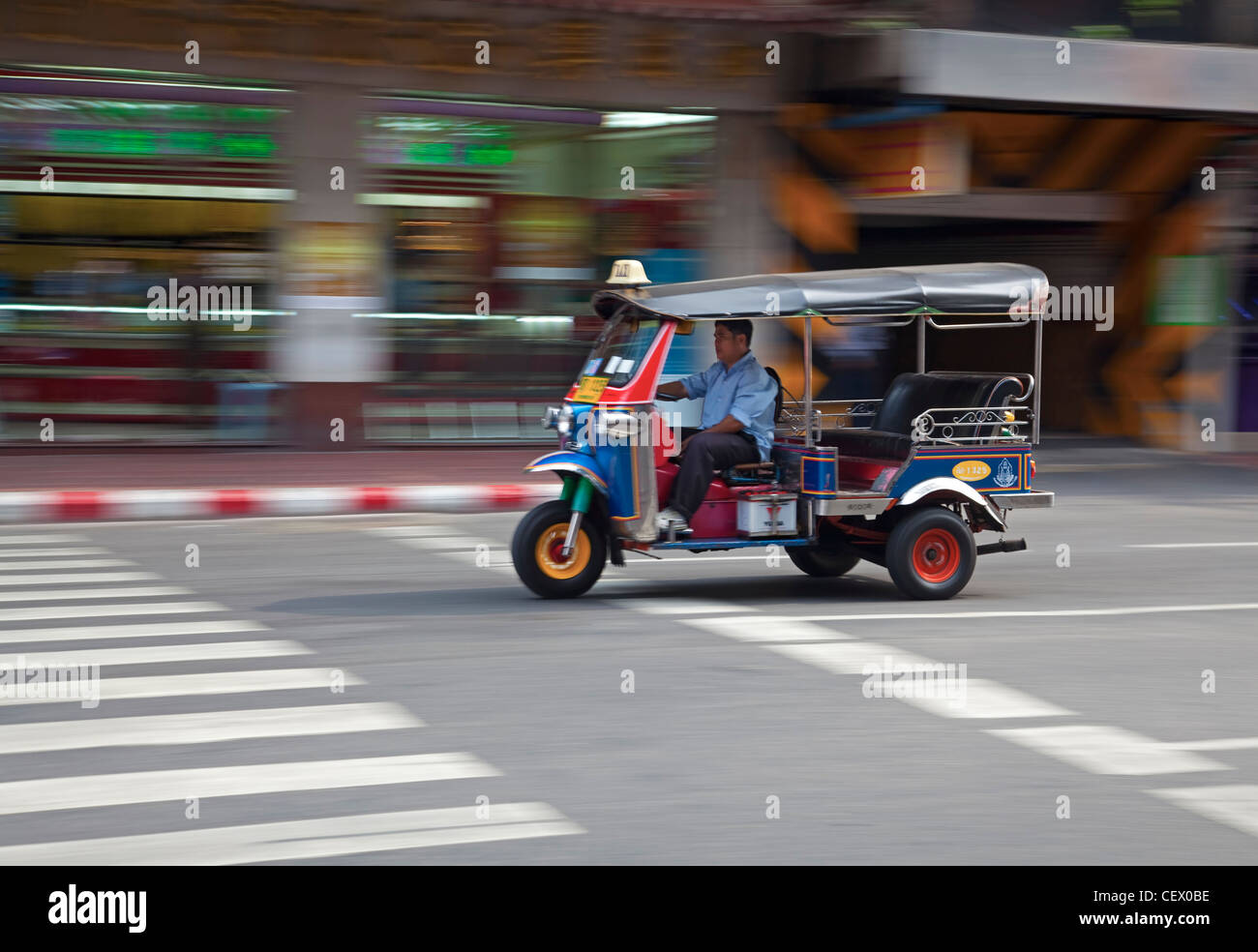 A tuk-tuk speeding through the streets of Bangkok, Thailand Stock Photo ...