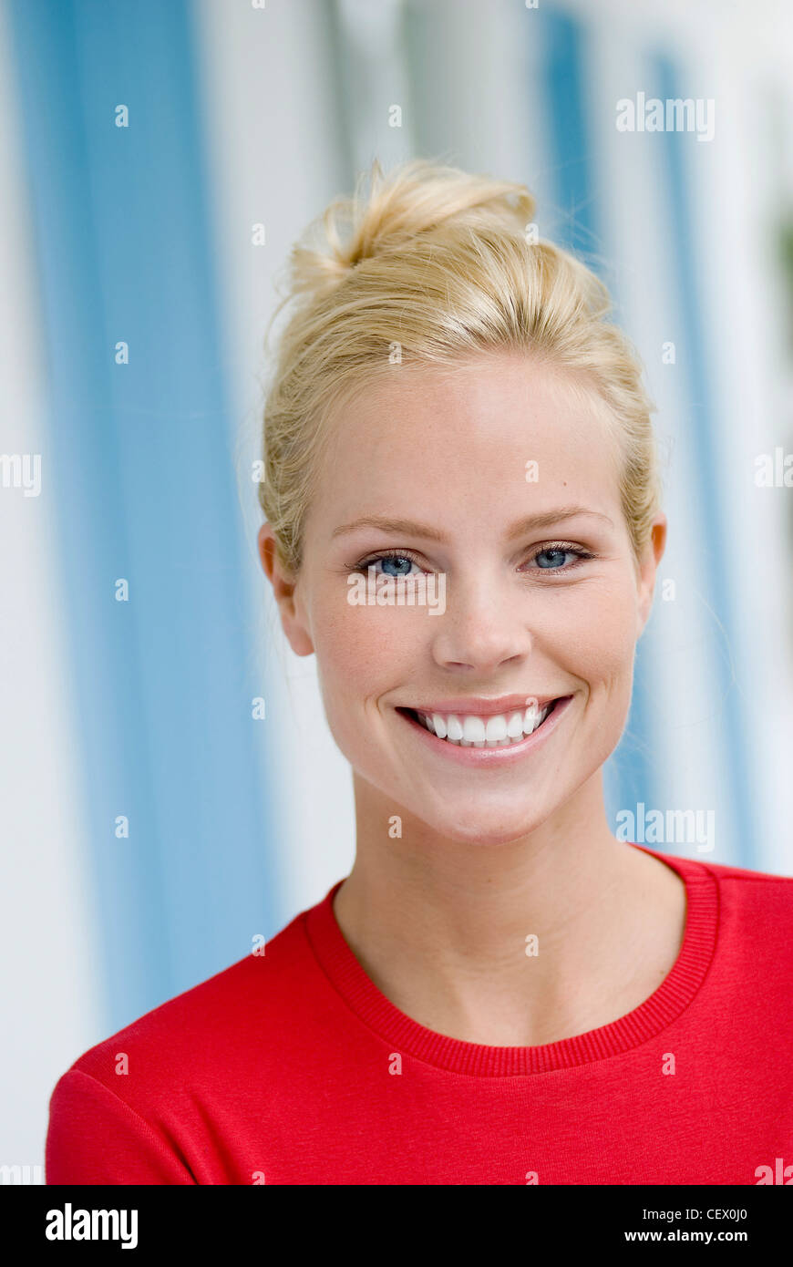 Female wearing red top smiling Stock Photo - Alamy