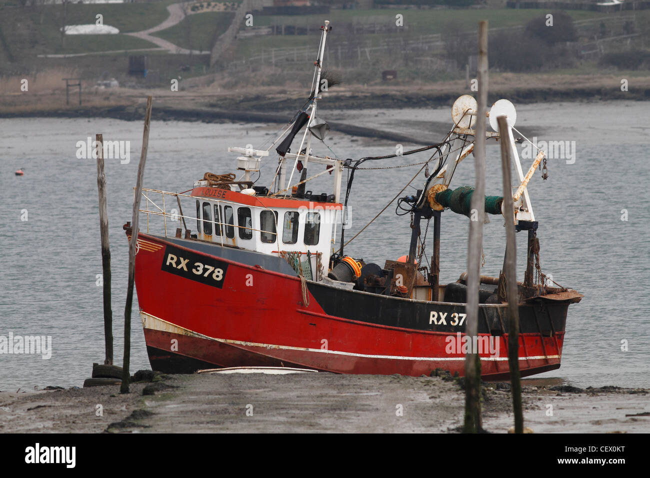 A fishing boat lying at the end of the slipway near Oare and Harty ...