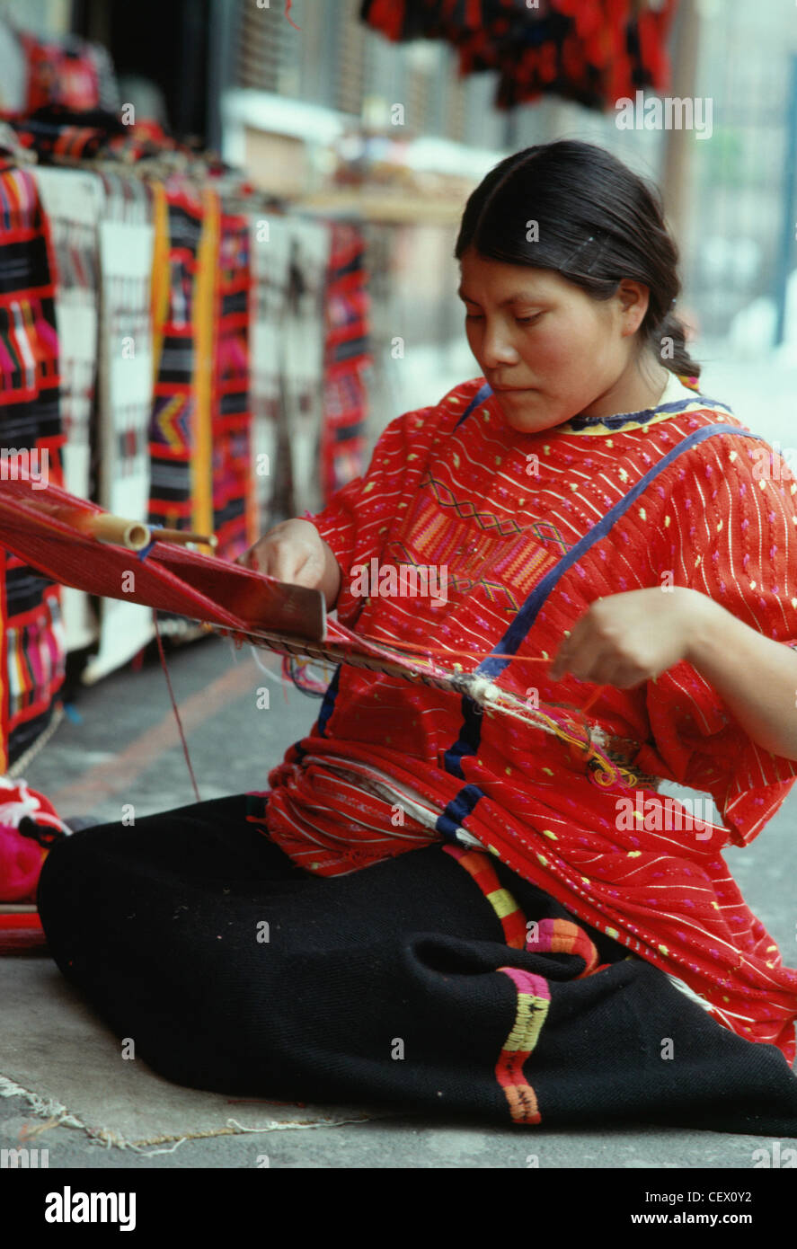 Woman in native Mexican costume weaves by hand in Zona Rosa, Mexico ...