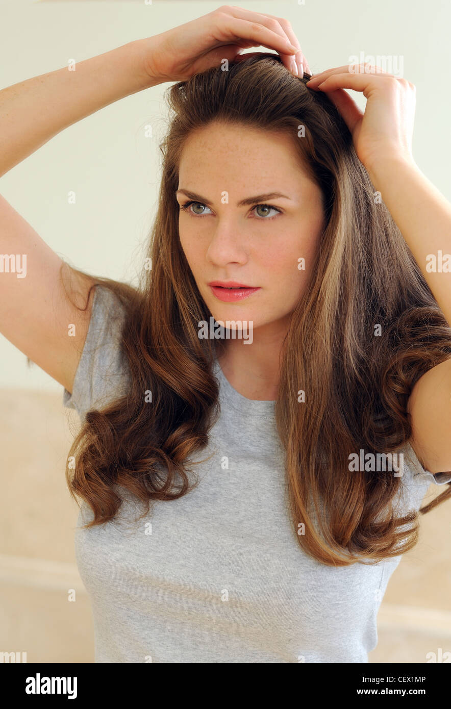WD1405-06 Female putting hair back with a clip Stock Photo - Alamy