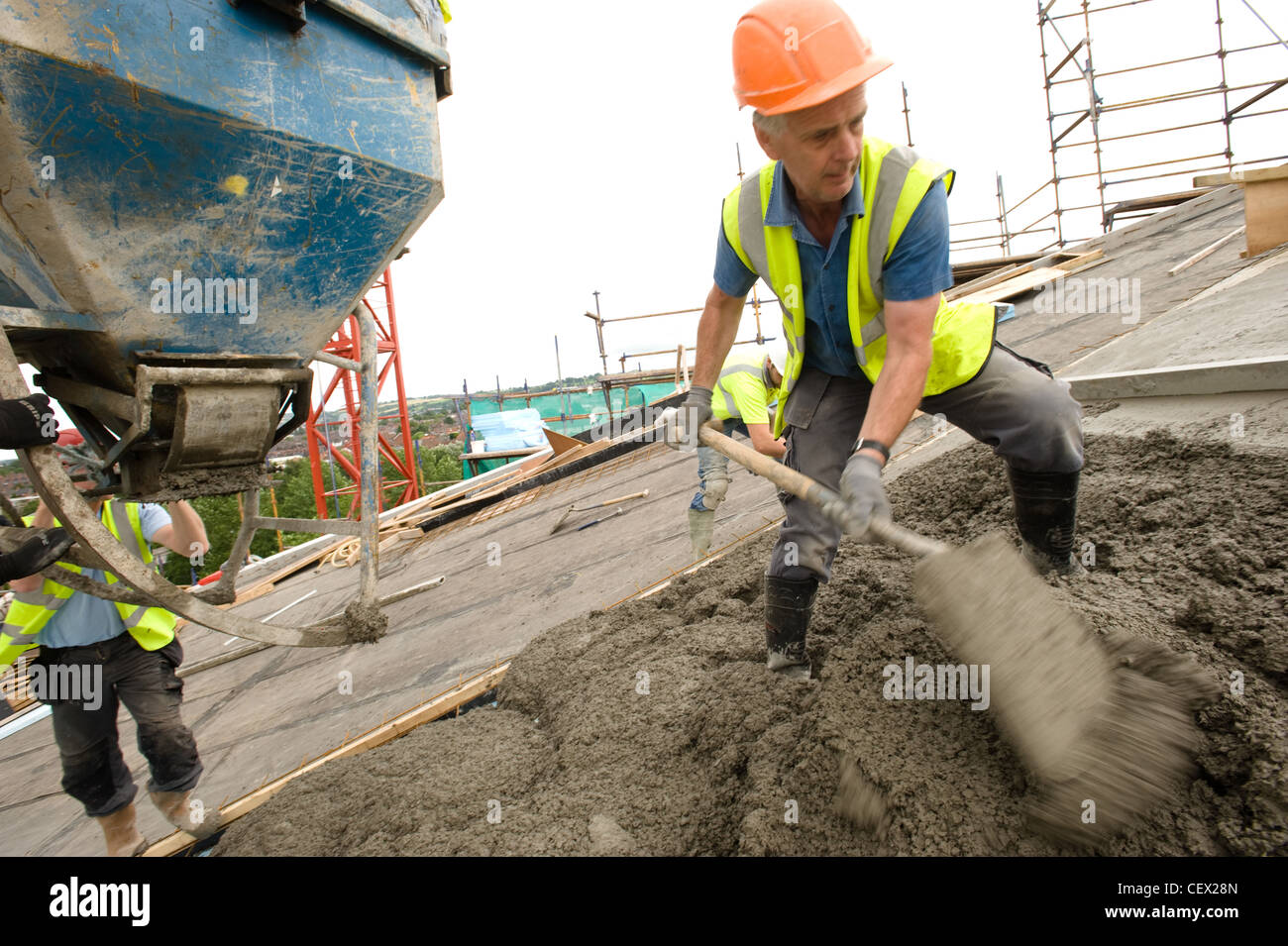 workmen pouring cement on building site Stock Photo - Alamy