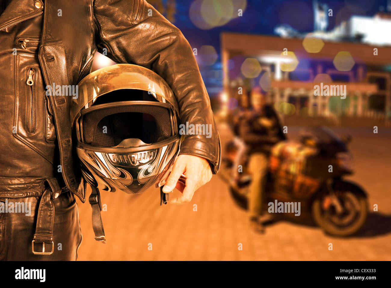 Biker closeup at night city background Stock Photo - Alamy