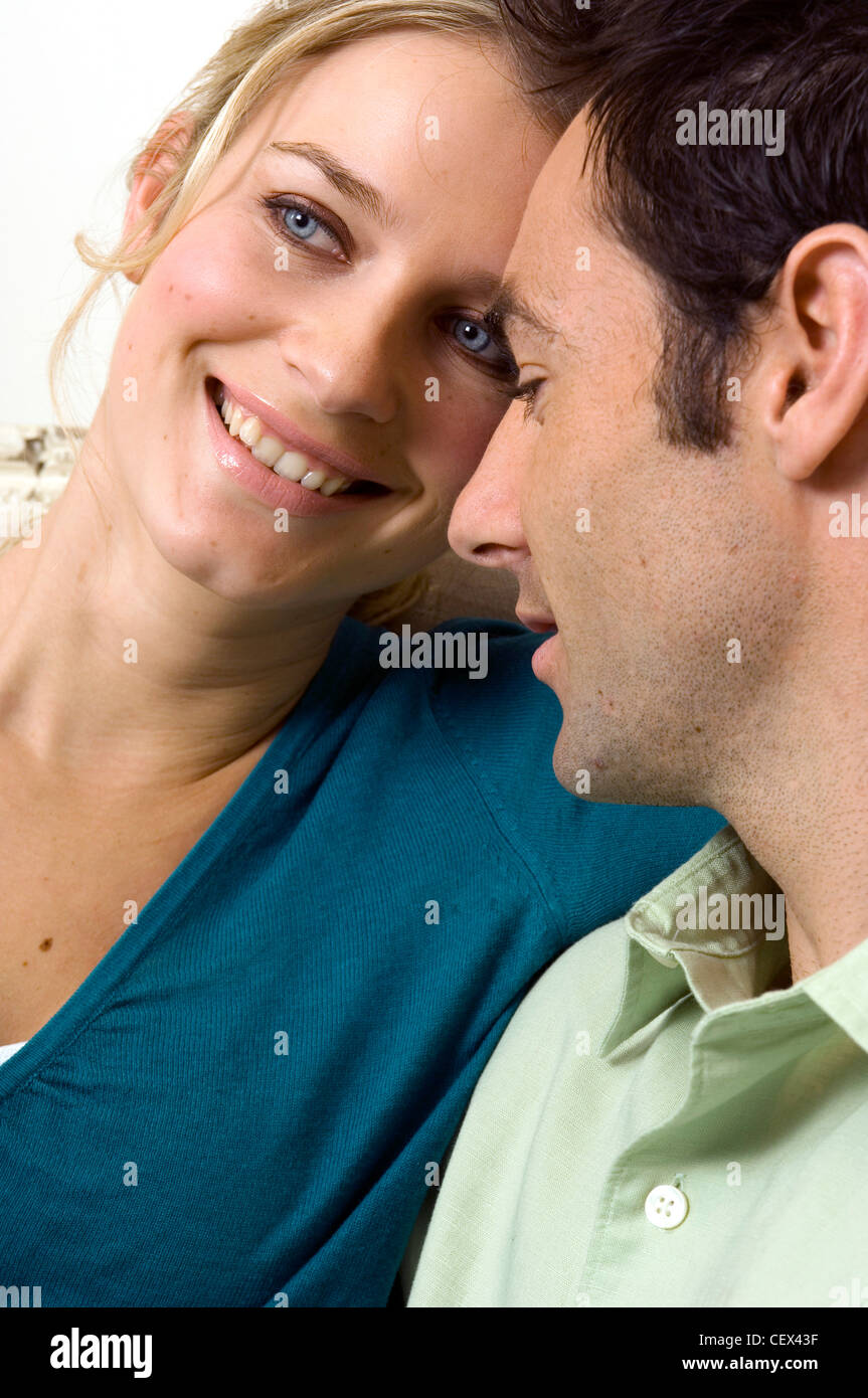 Couple sitting close together Stock Photo - Alamy