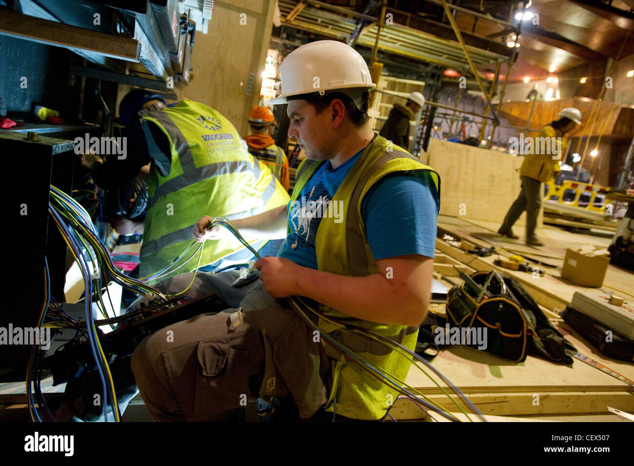 Electrician installing cabling, working on a building site Stock Photo ...