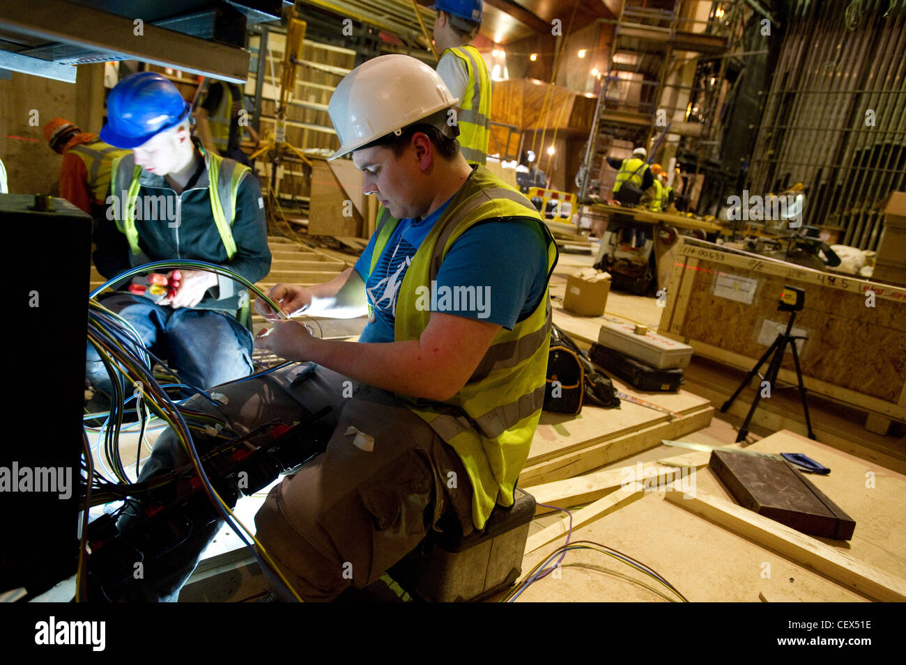 Electrician installing cabling, working on a building site Stock Photo ...